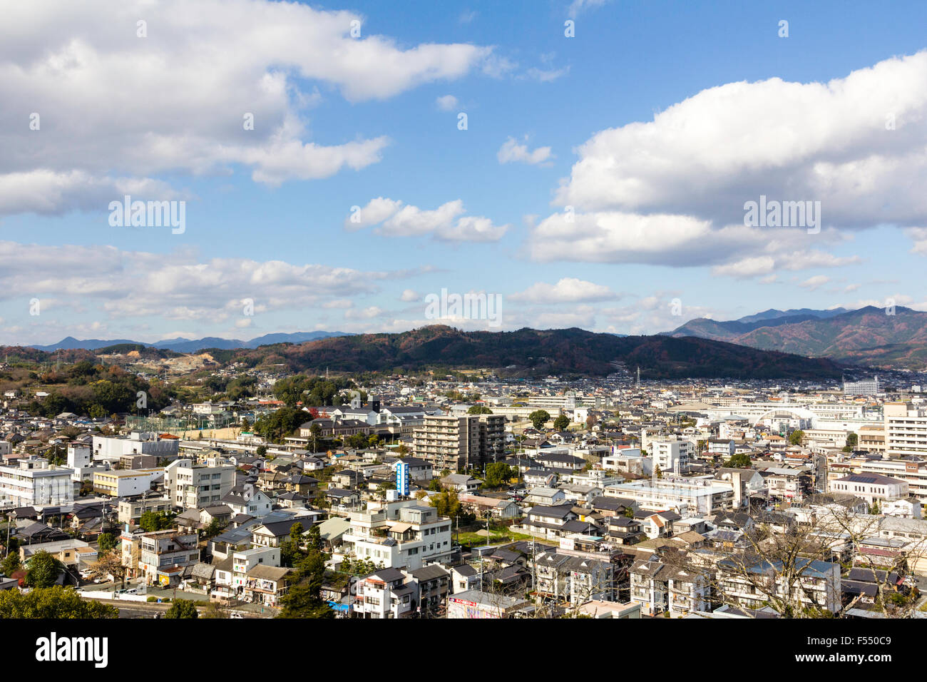 Tsuyama city seen from the hilltop castle. Mostly white buildings, two ...