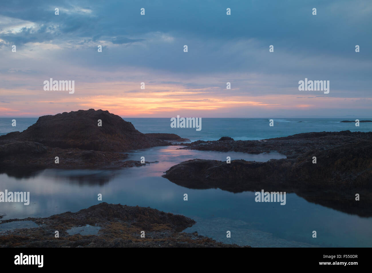 Long exposure of rocks in waves, giving a mist like effect over ocean ...