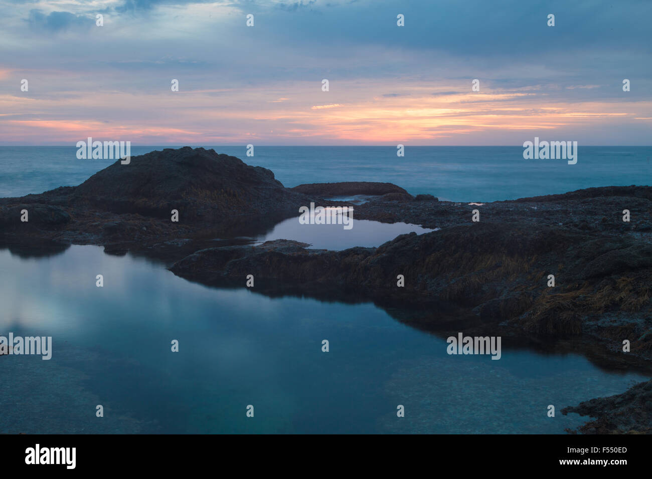 Long exposure of rocks in waves, giving a mist like effect over ocean ...