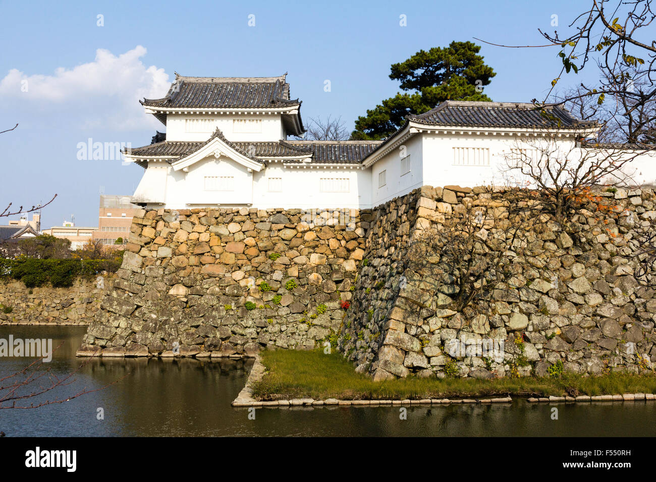 Japan, Osaka, Kishiwada castle. View across moat of the stone base with ...