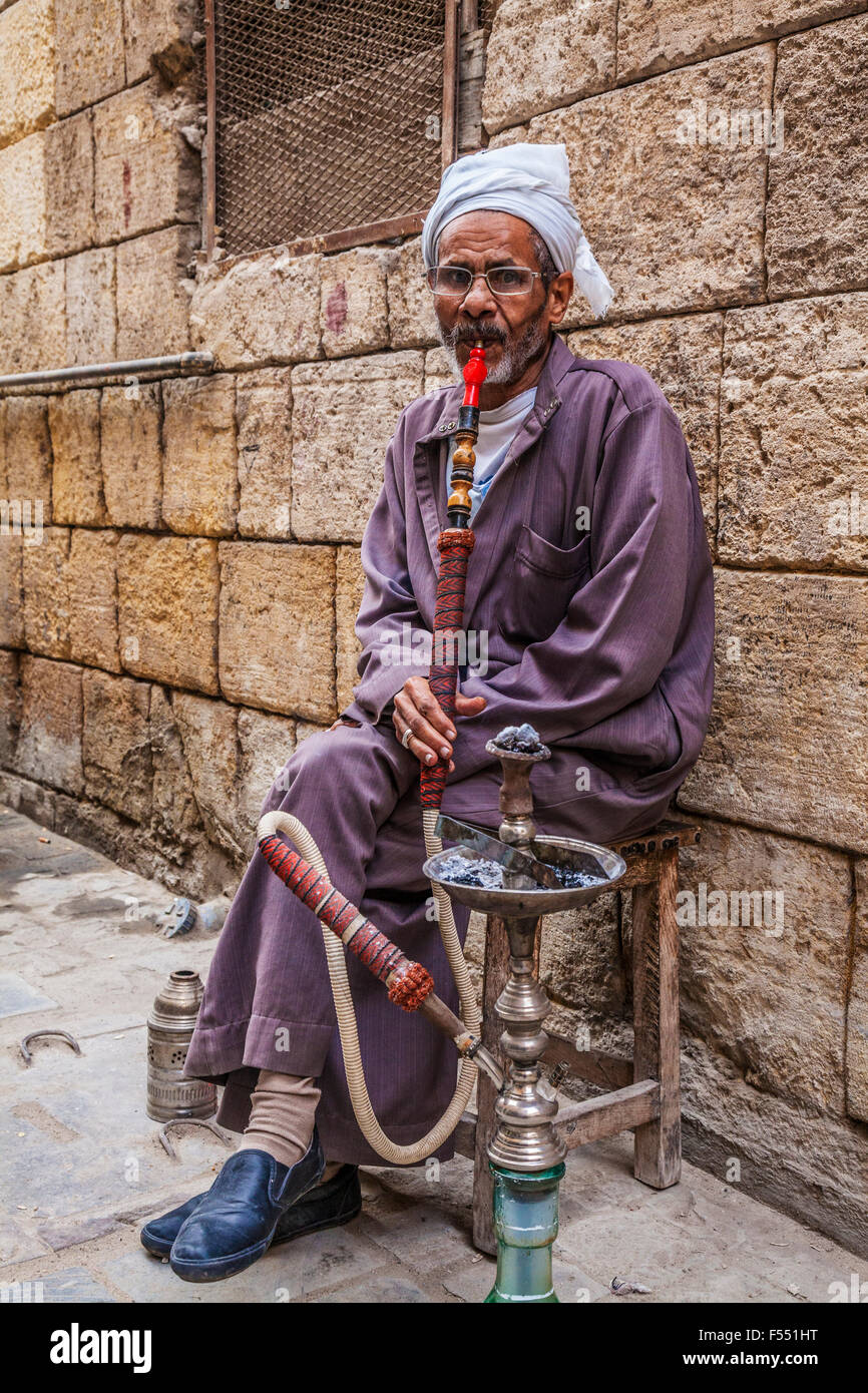 Arab man smokes a traditional Arabian shisha in the Khan el-Khalili ...