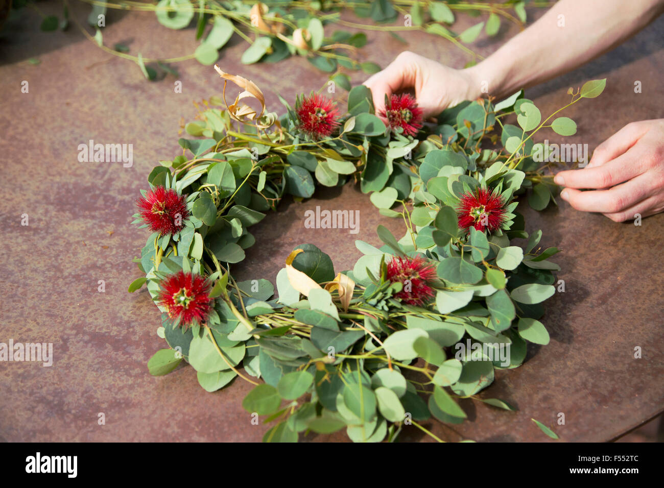 Cropped hand making wreath outdoors Stock Photo - Alamy