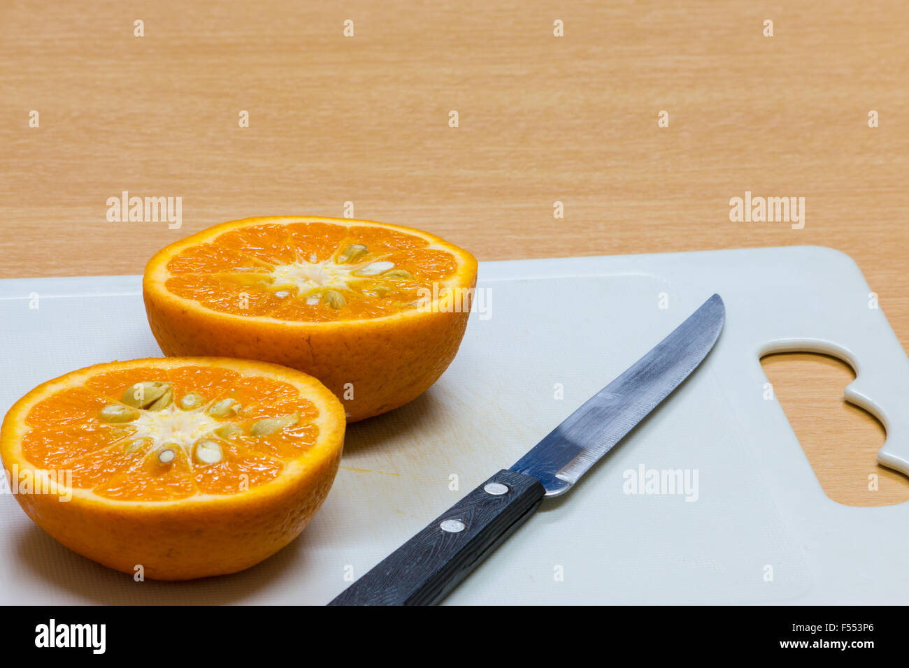 pieces of orange, a little knife cut orange to two pieces on the ...