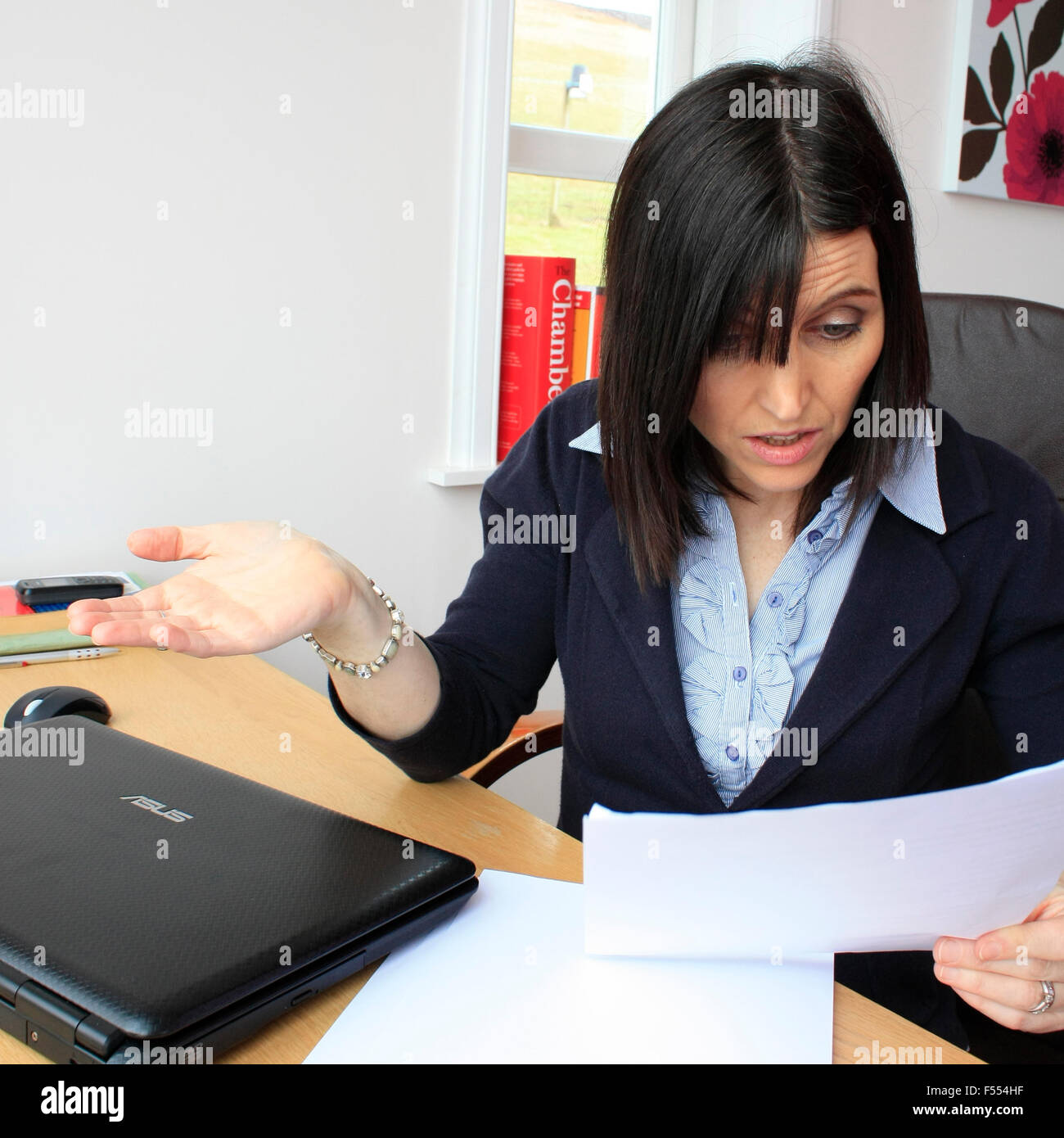 Woman reading stressful letter Stock Photo - Alamy