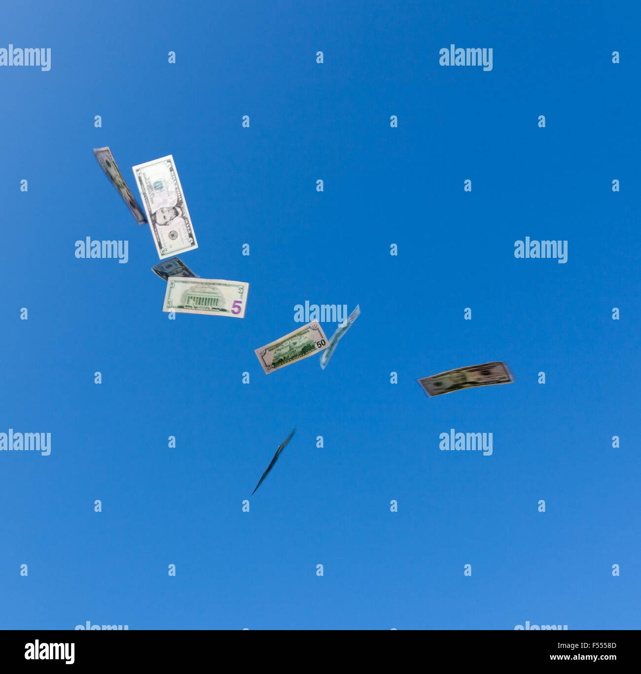 Various dollar notes falling from above Stock Photo - Alamy