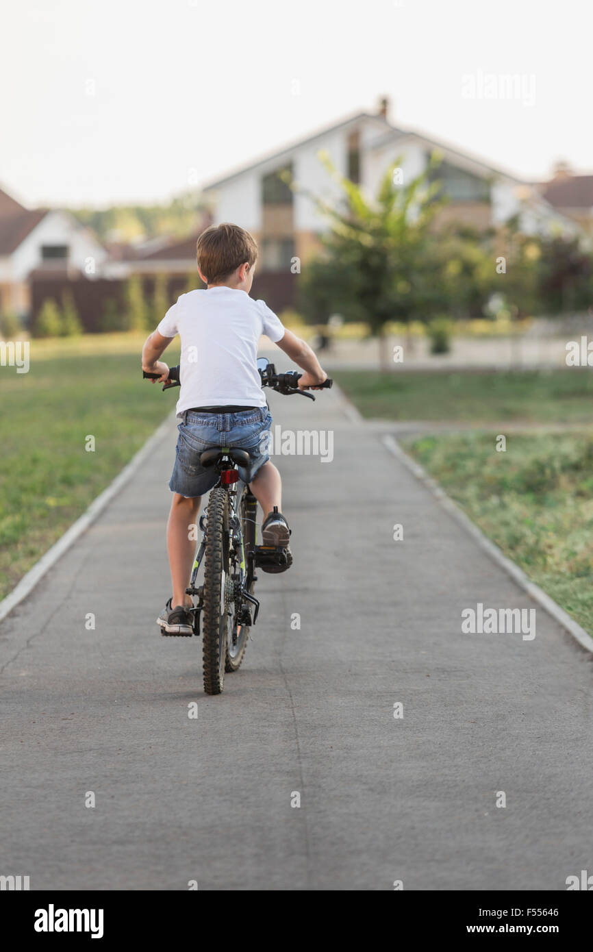 Back view boy on bicycle hi-res stock photography and images - Alamy