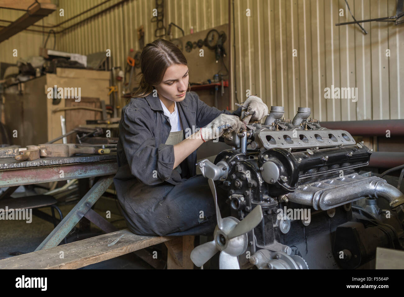 Female mechanic repairing car engine at garage Stock Photo - Alamy