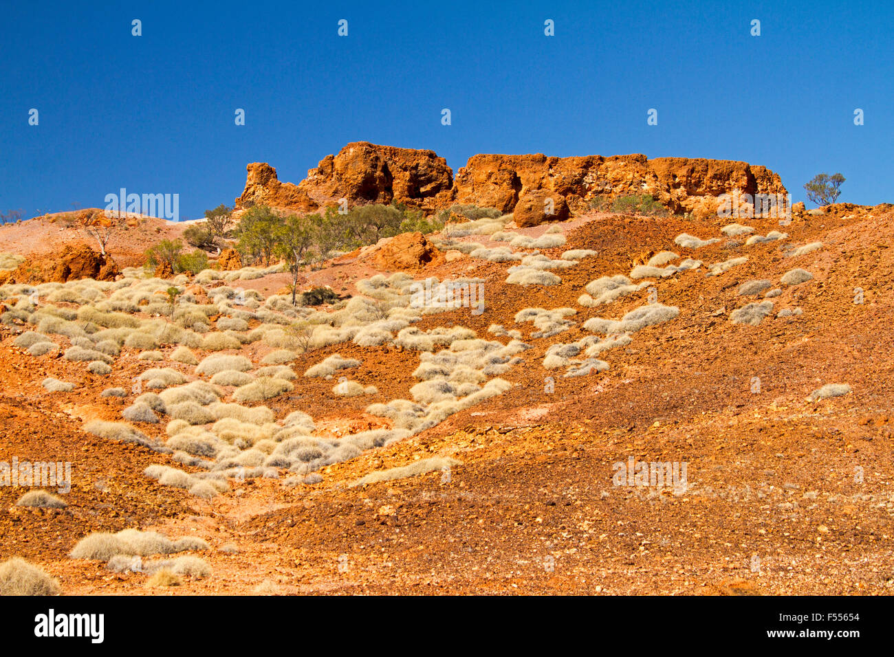 Australian outback landscape with rugged red rocky hill and barren ...