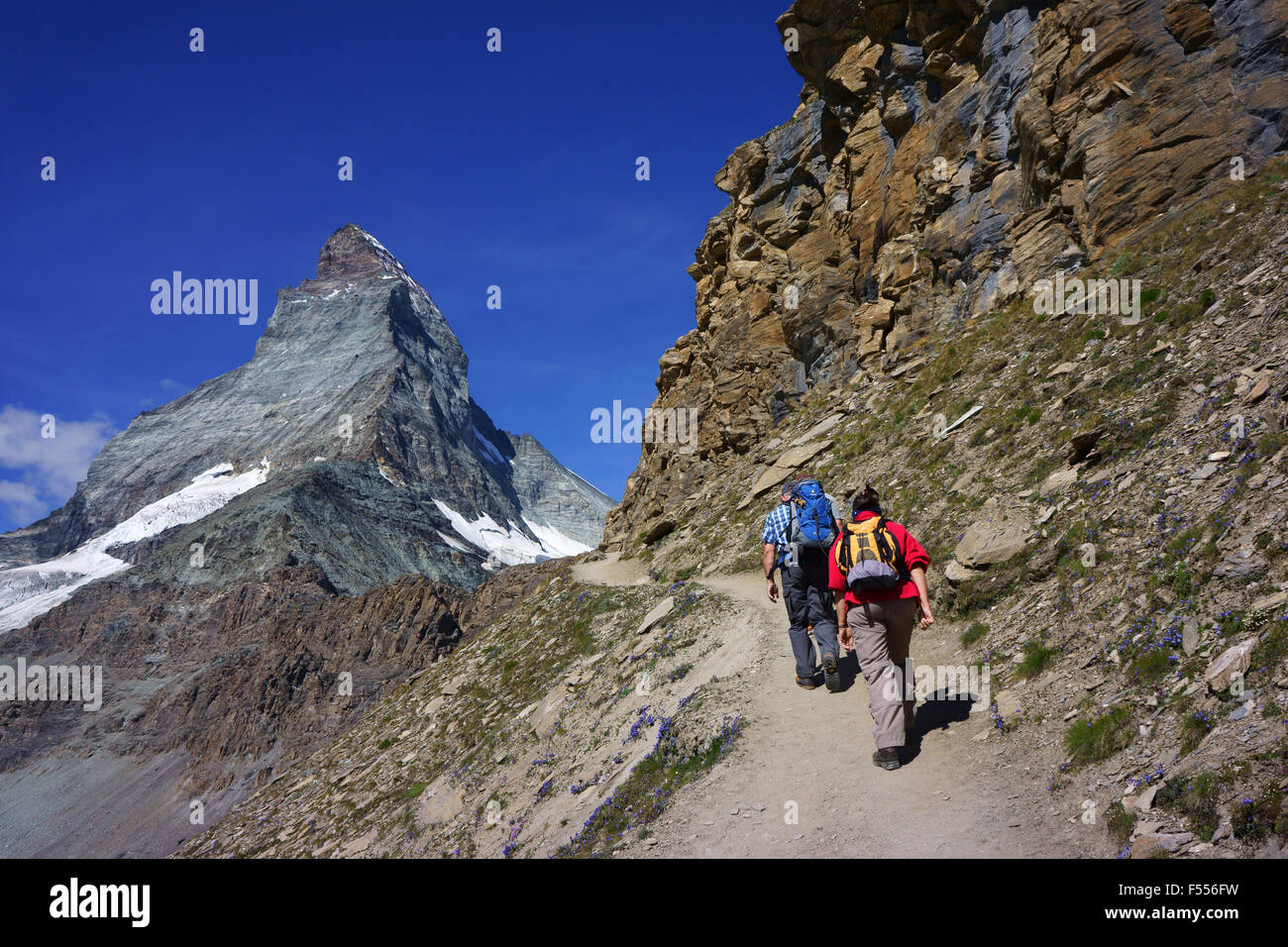 Hikers on trail to the Hörnli hut at abse of Matterhorn, Zermatt, Swiss ...
