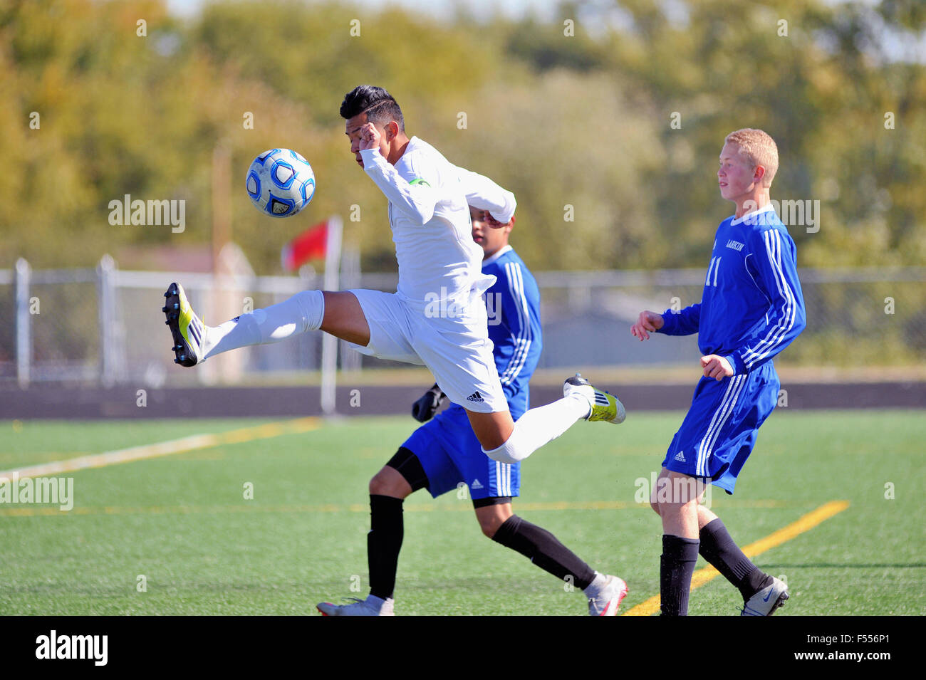 A high school player gets well off the pitch in an effort to redirect ...