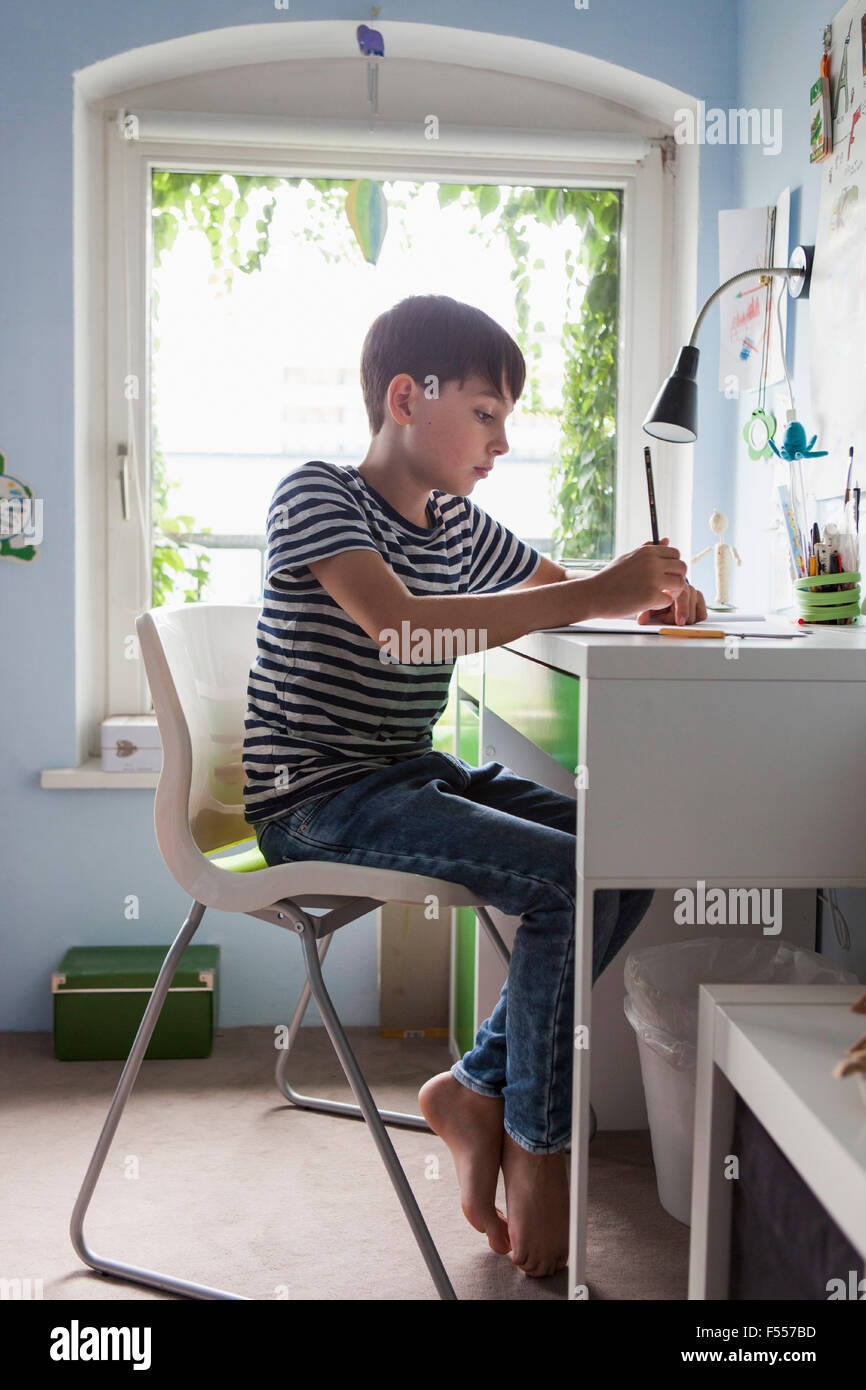 Boy sitting desk homework hi-res stock photography and images - Alamy