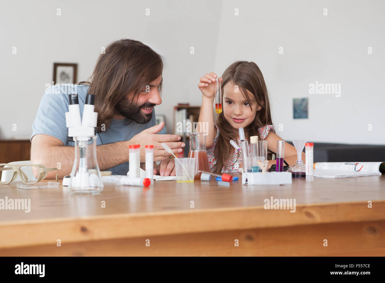 Father and daughter doing science experiment at home Stock Photo - Alamy