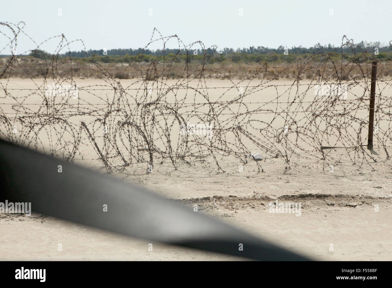 Barbed wire fence on field Stock Photo - Alamy