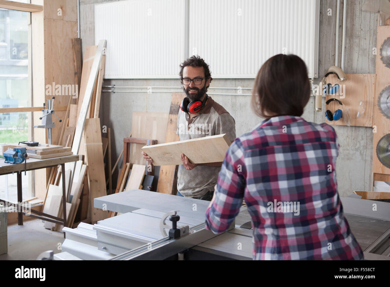 Male and female carpenters working together in workshop Stock Photo - Alamy