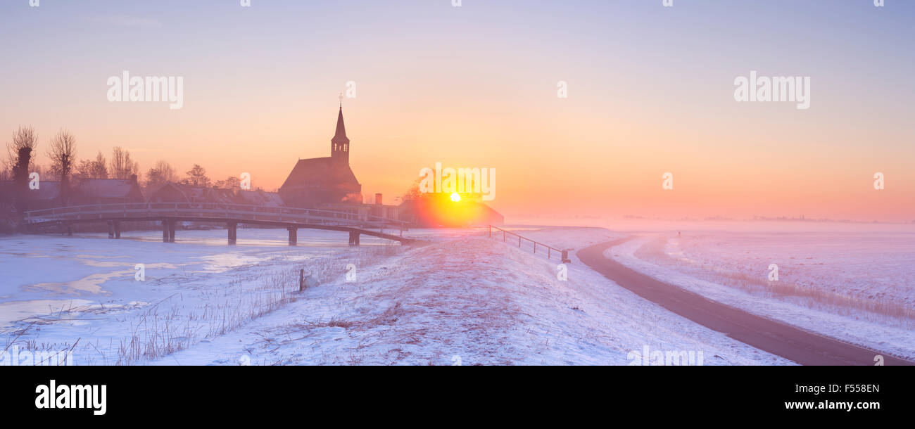 A church in a frozen winter landscape in The Netherlands. Photographed ...