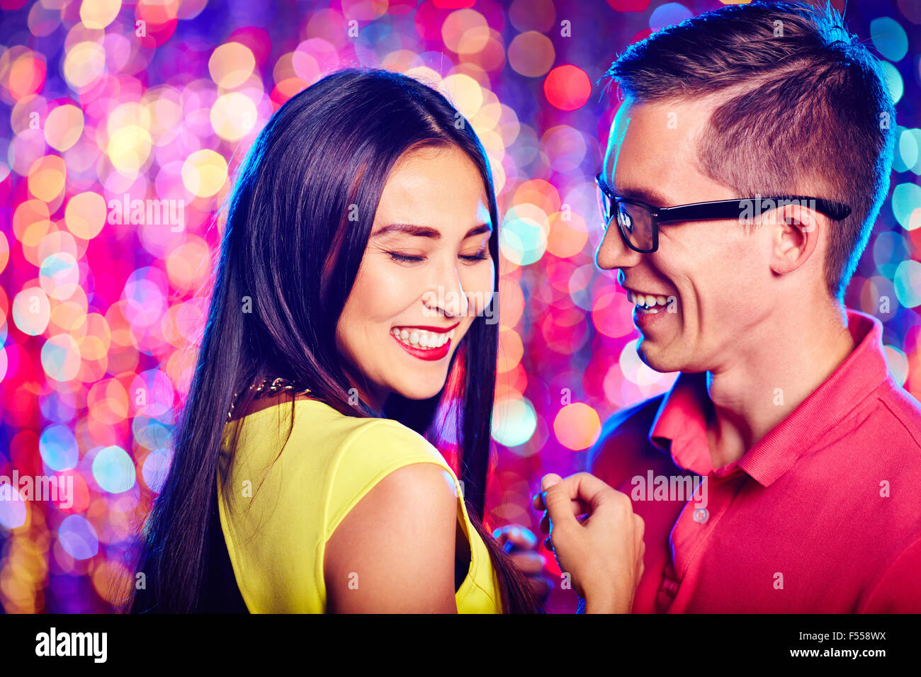 Cheerful couple laughing at party Stock Photo - Alamy