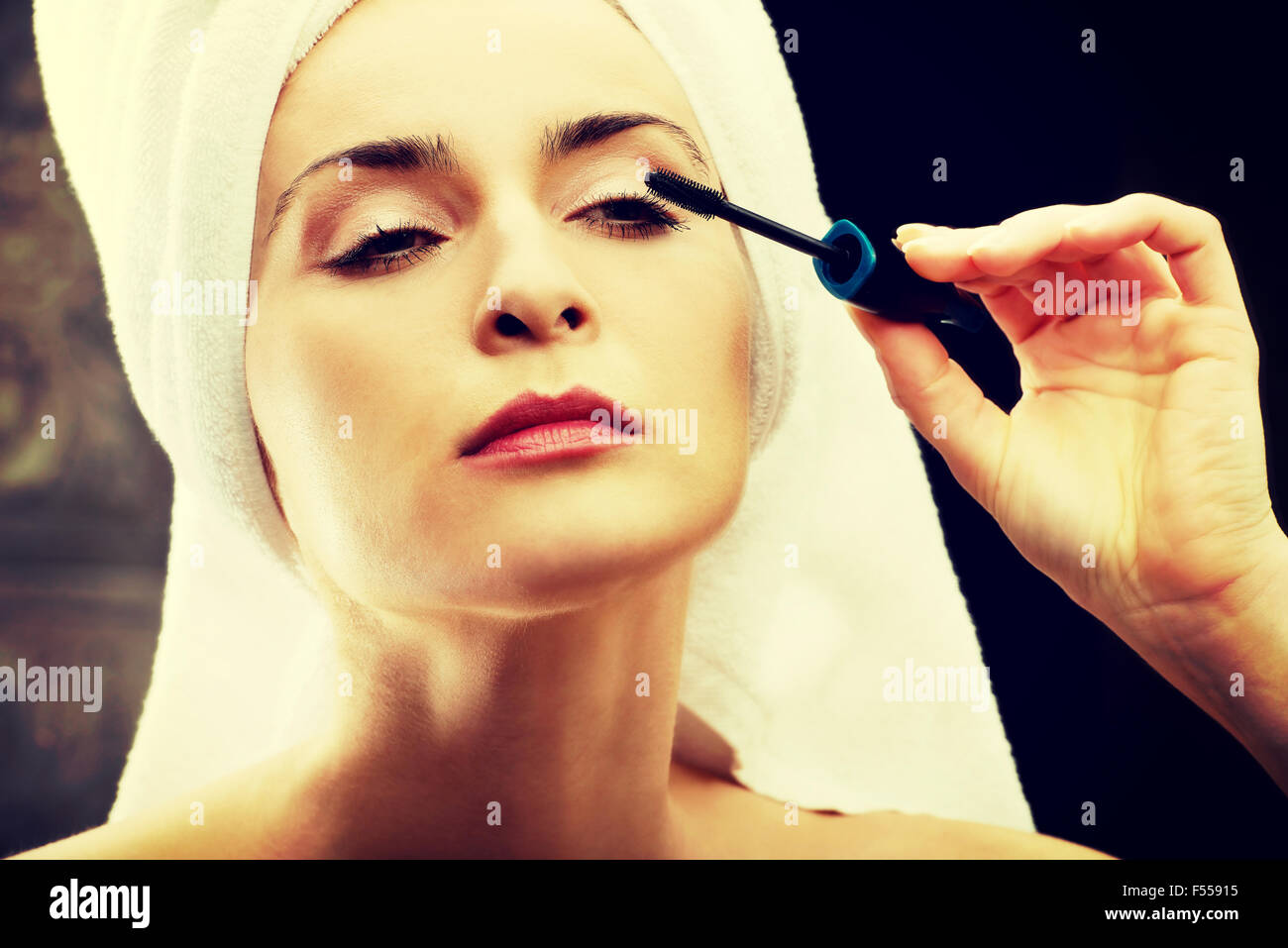 Woman makes light day makeup in bathroom Stock Photo - Alamy