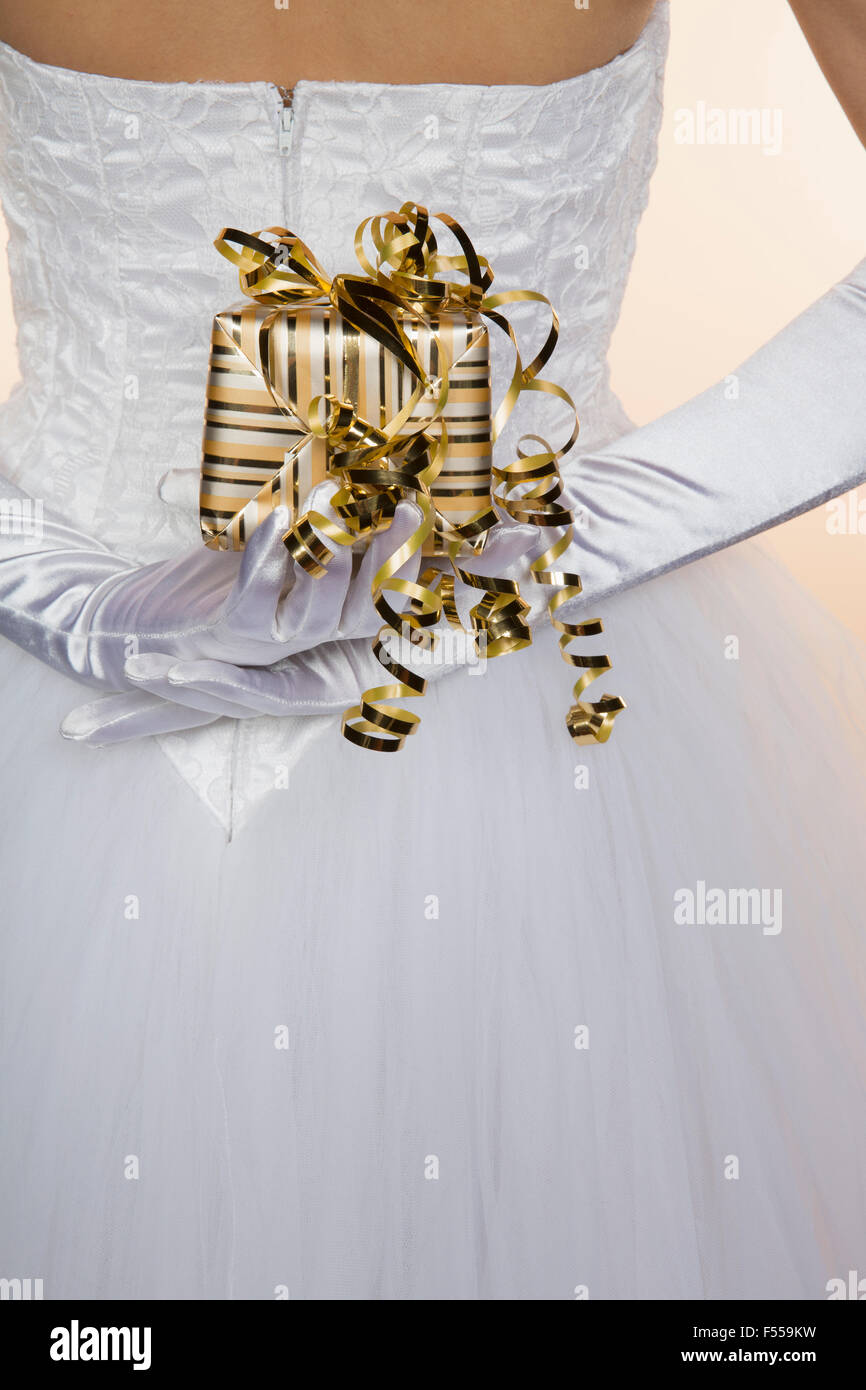 Rear view midsection of bride holding gift box Stock Photo - Alamy