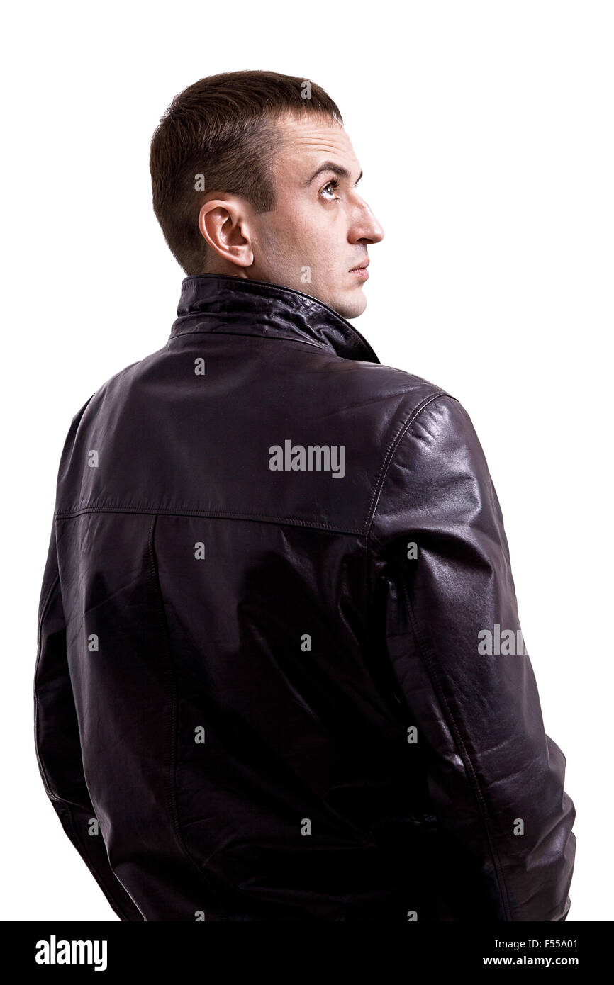 Side view of a serious young man in leather jacket looking away from ...