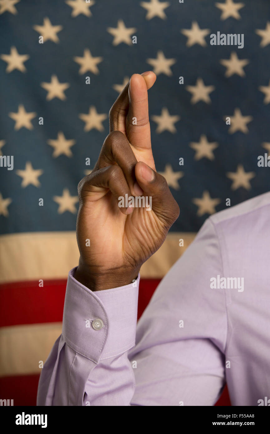 Cropped image of man crossing fingers against American flag Stock Photo ...