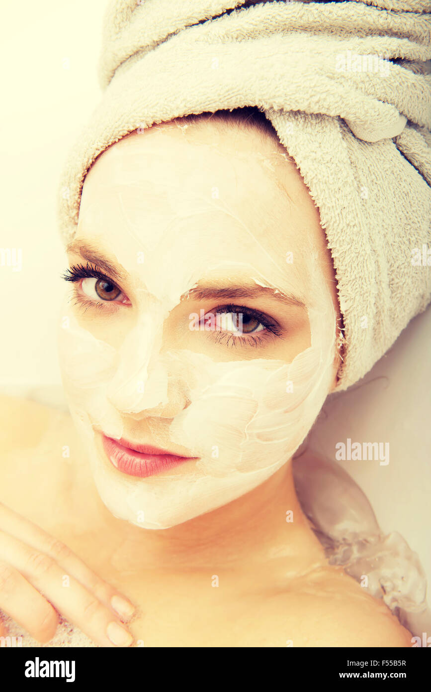Woman relaxing in bathtub with face mask Stock Photo - Alamy
