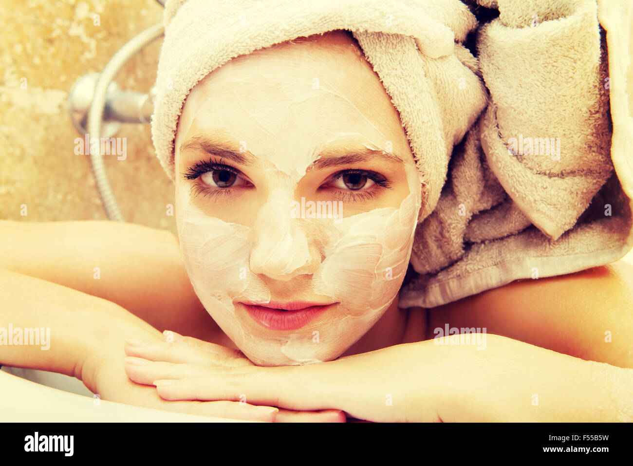 Woman relaxing in bathroom with face mask Stock Photo - Alamy