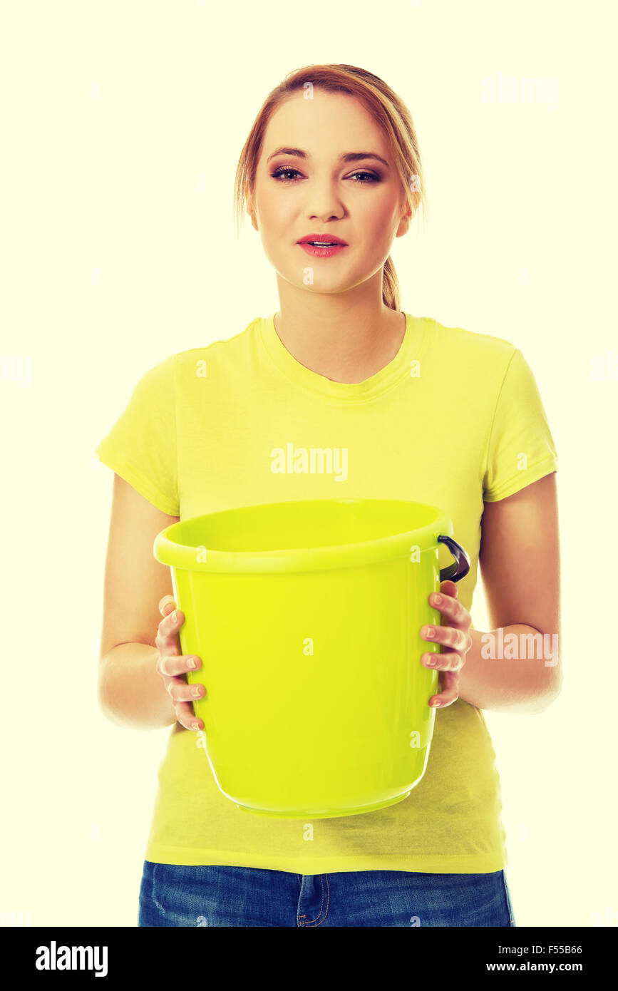 Young woman holding green bucket Stock Photo - Alamy