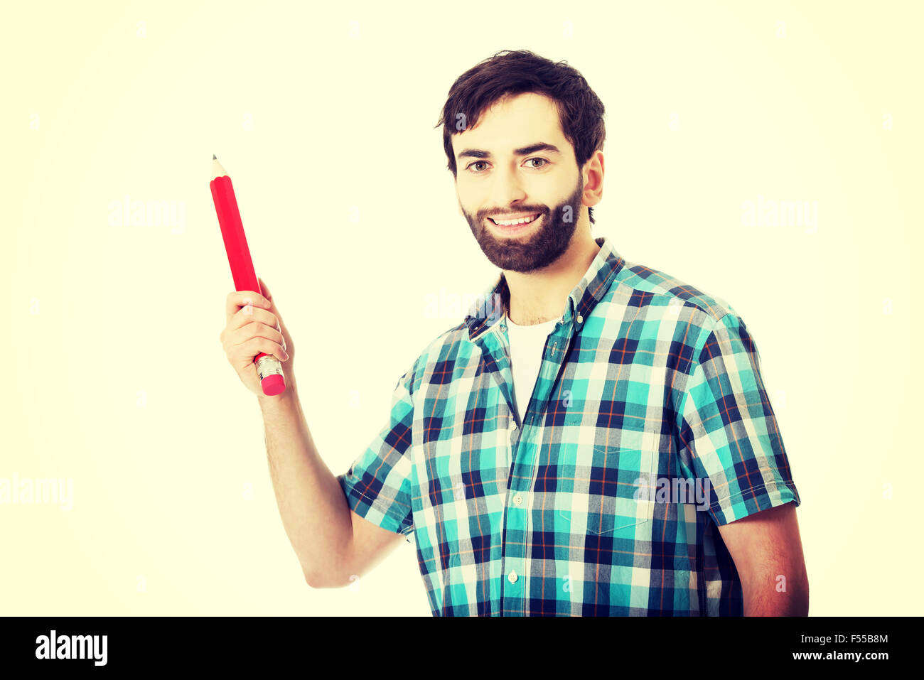 Young man holding big red pencil Stock Photo - Alamy