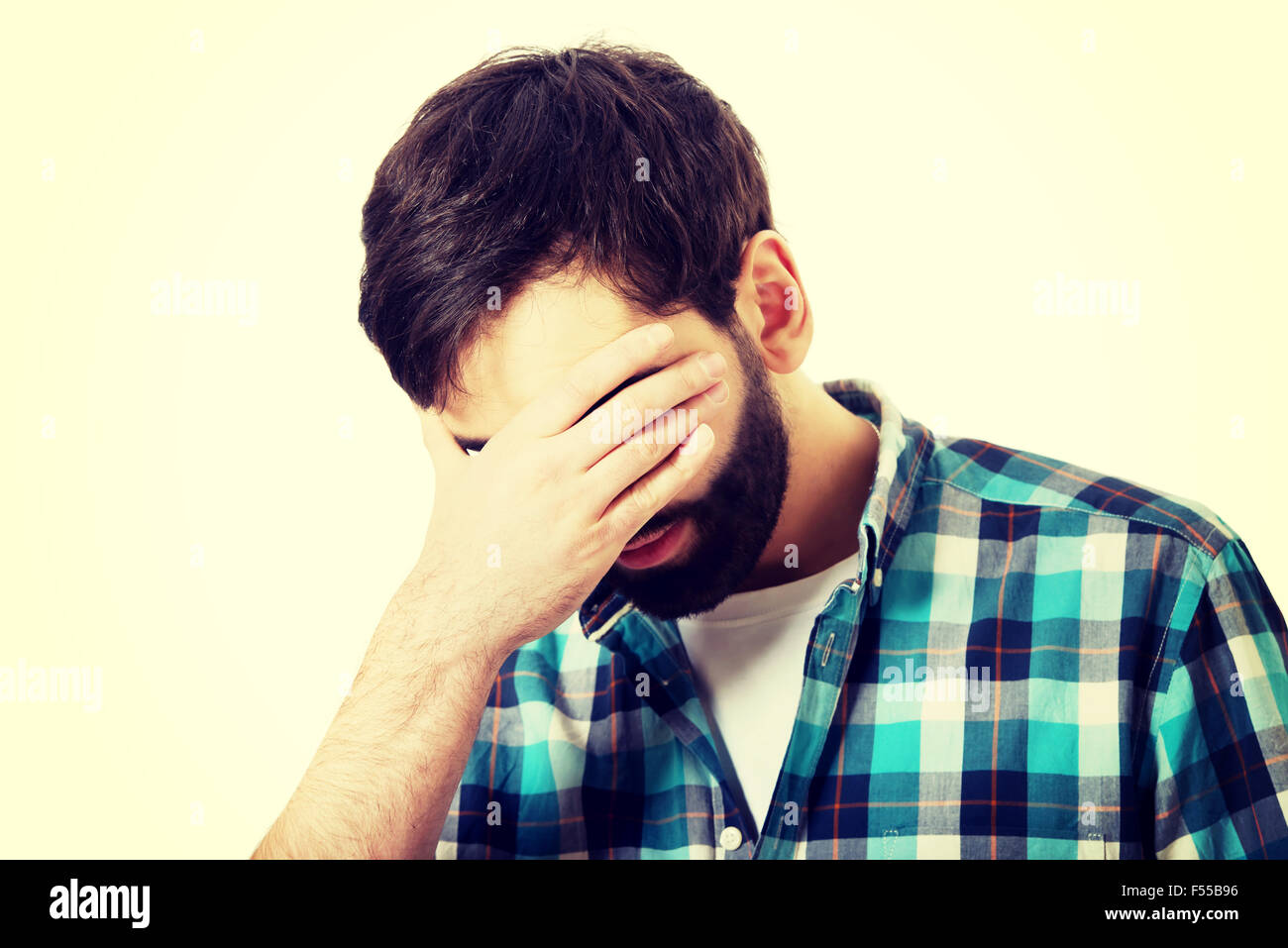 Young man touching face hi-res stock photography and images - Alamy