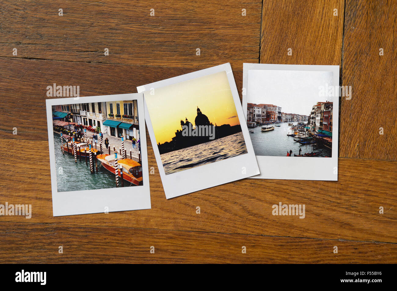 Instant print photographs of famous places on wooden table Stock Photo ...