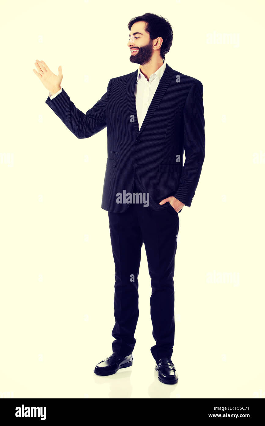 Young businessman presenting something hi-res stock photography and ...