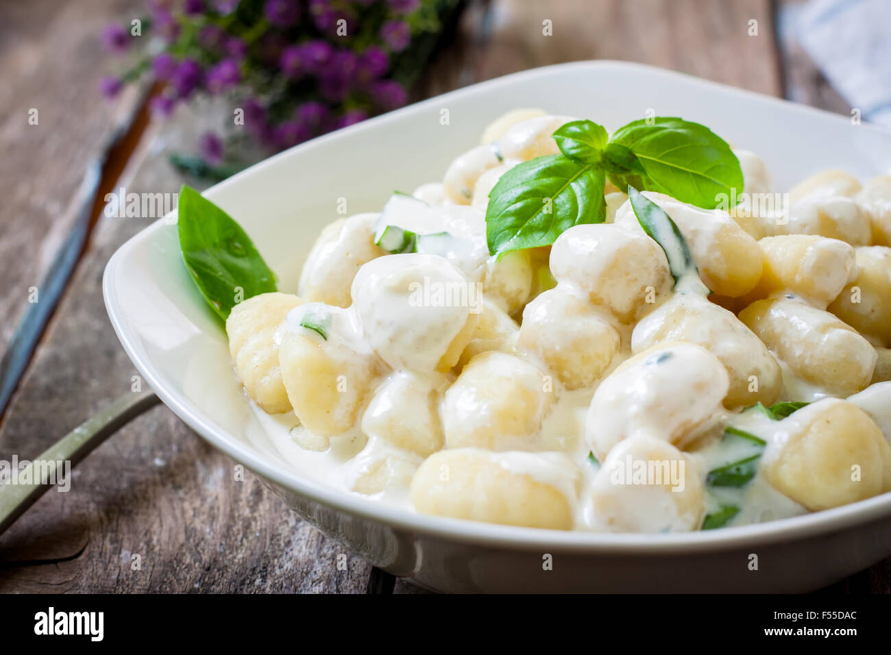 potato gnocchi pasta with cheese sauce and basil Stock Photo - Alamy