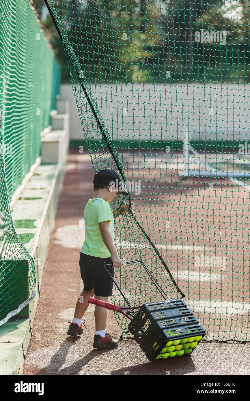 Boy pulling trolley in court Stock Photo - Alamy
