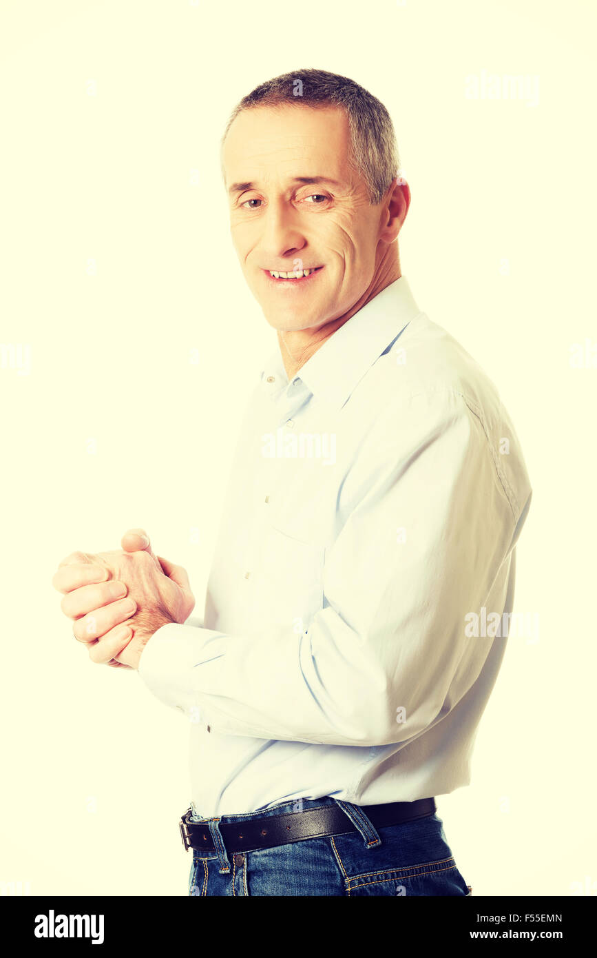 Handsome man with clenched hands Stock Photo - Alamy