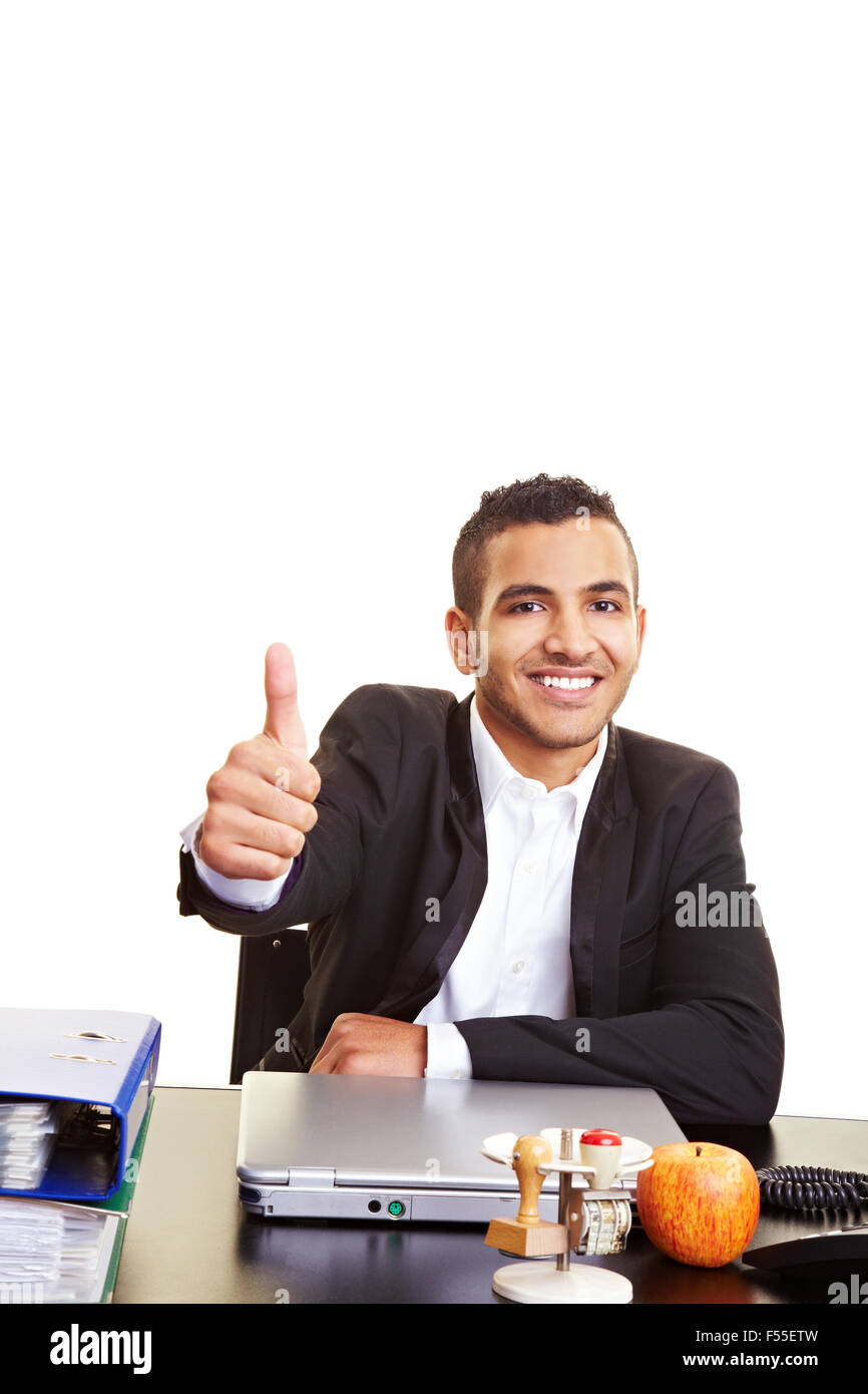 Young manager at his desk holding his thumb up Stock Photo - Alamy