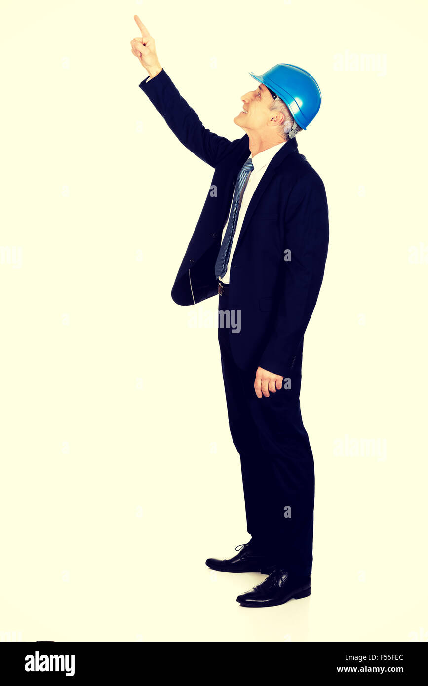Businessman engineer pointing up Stock Photo - Alamy