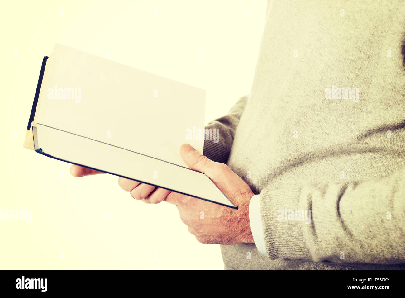 Hands holding book hi-res stock photography and images - Alamy