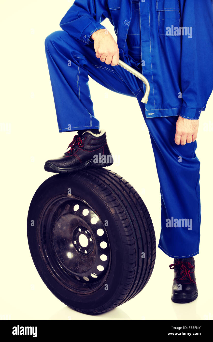 Repairman leg on a tire Stock Photo - Alamy