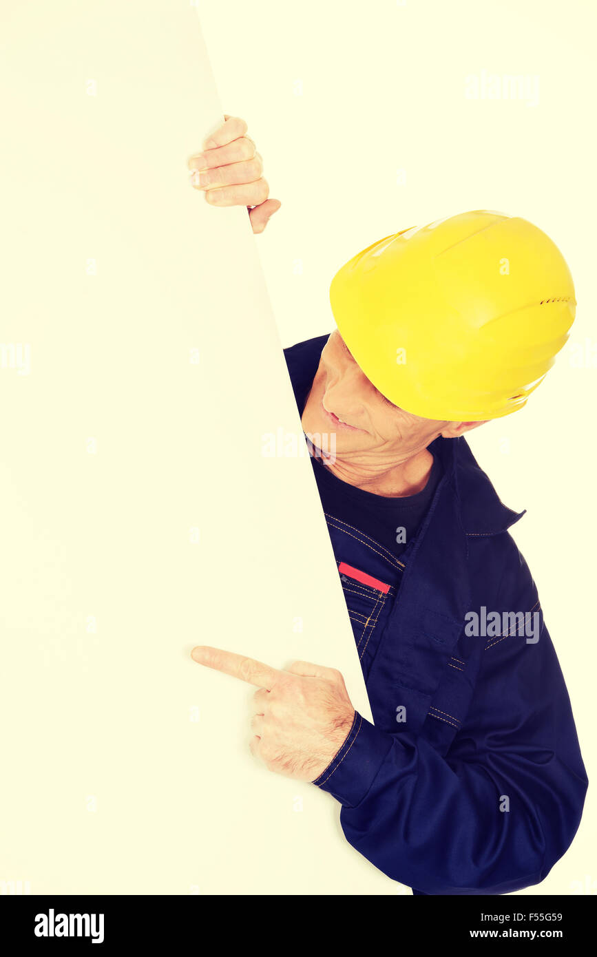Happy worker presenting empty banner Stock Photo - Alamy