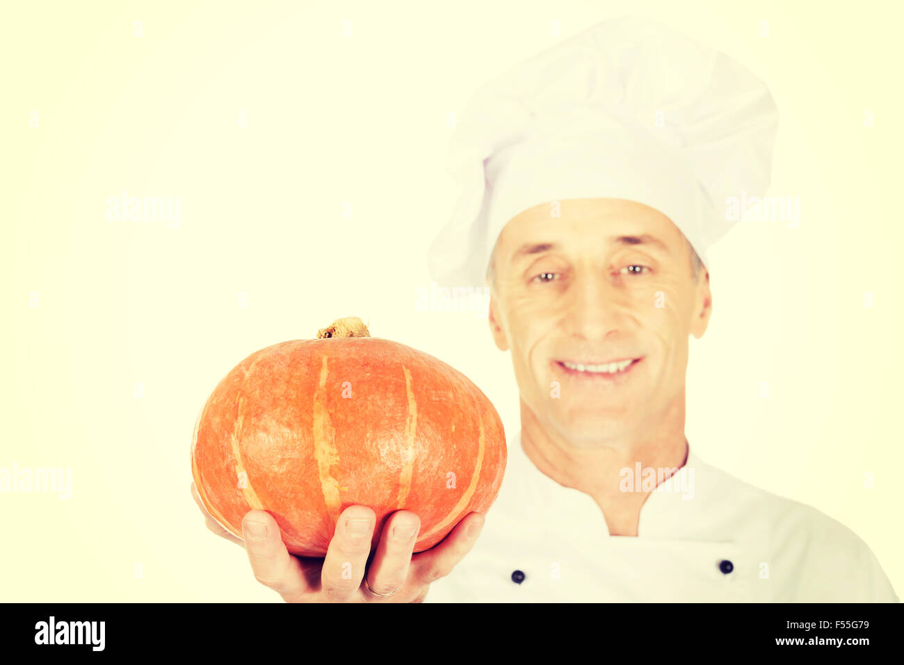 Male chef with a pumpkin Stock Photo - Alamy