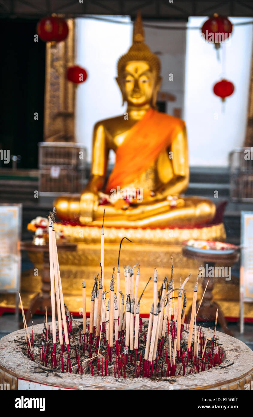 Thailand, Bangkok, vessel with burnt down joss sticks with golden ...