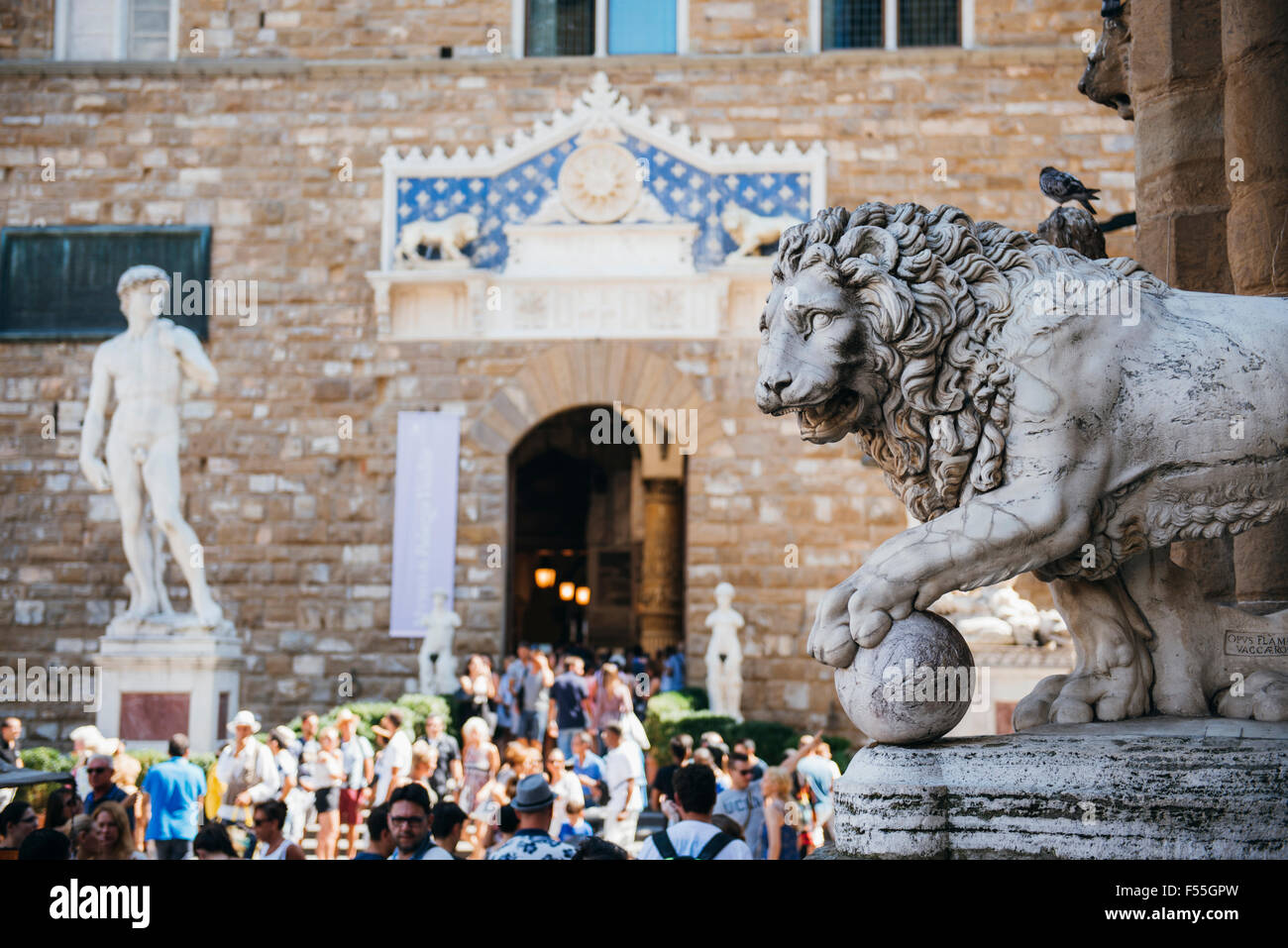 Italy, Florence, Stone lion and replica of Michelangelo's David at ...