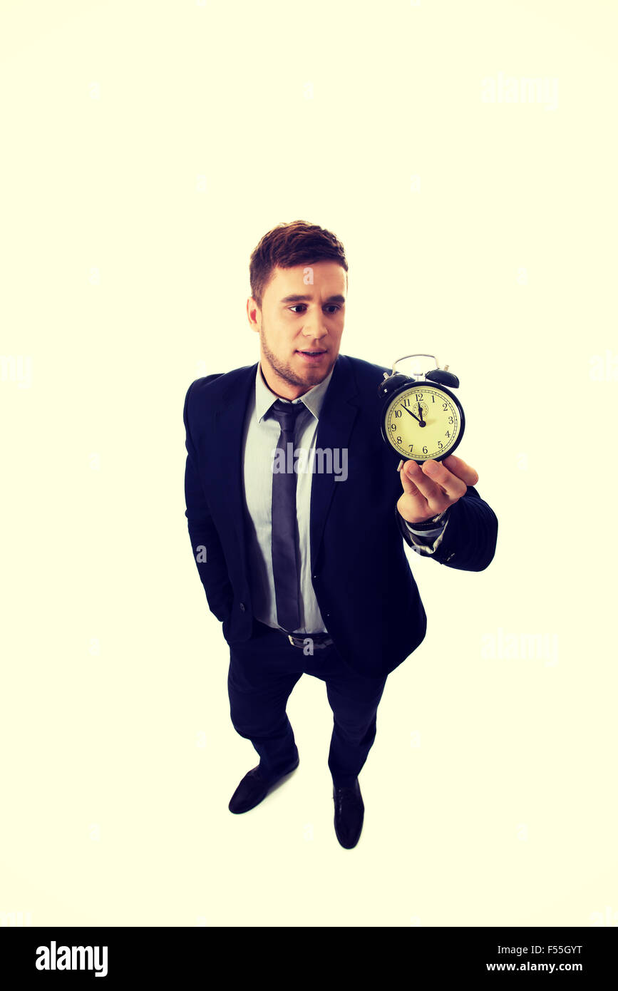 Businessman with alarm clock Stock Photo - Alamy