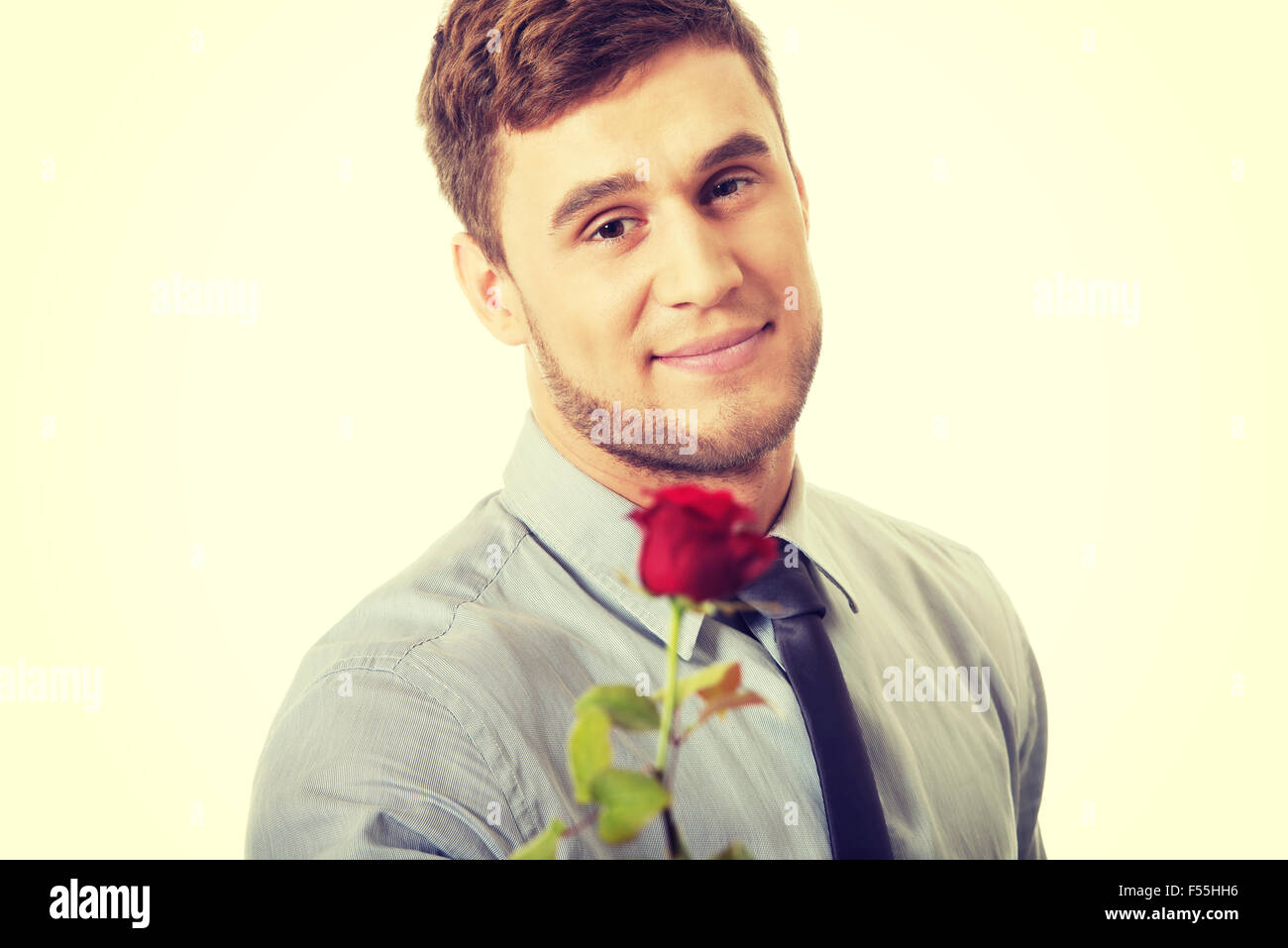 Handsome man holding red rose Stock Photo - Alamy