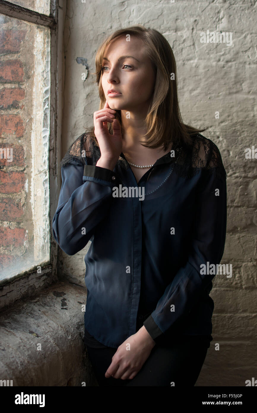 Sad woman looking out of window hi-res stock photography and images - Alamy