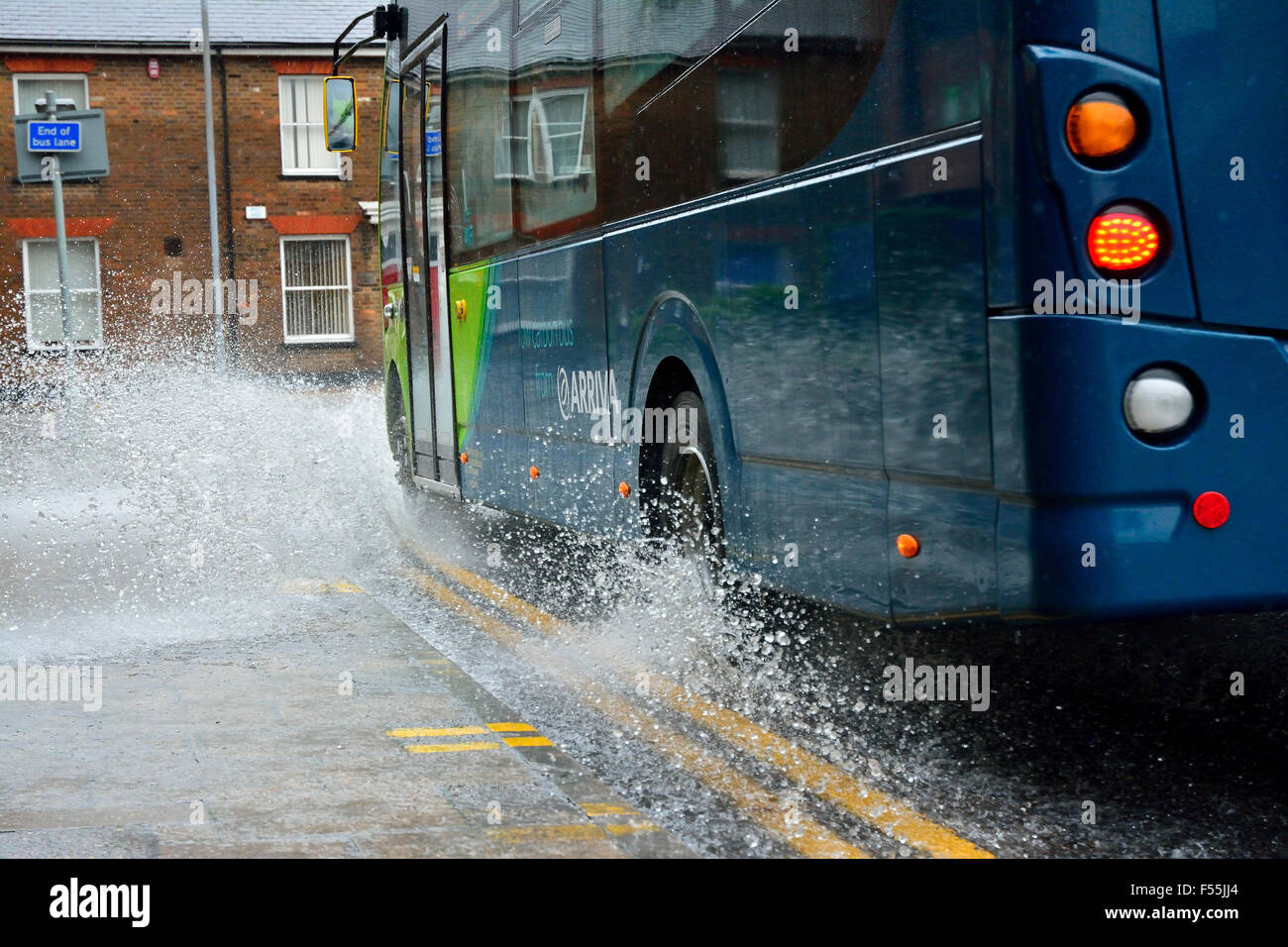 Bus driving through rain puddles in Luton, Bedfordshire, England Stock ...