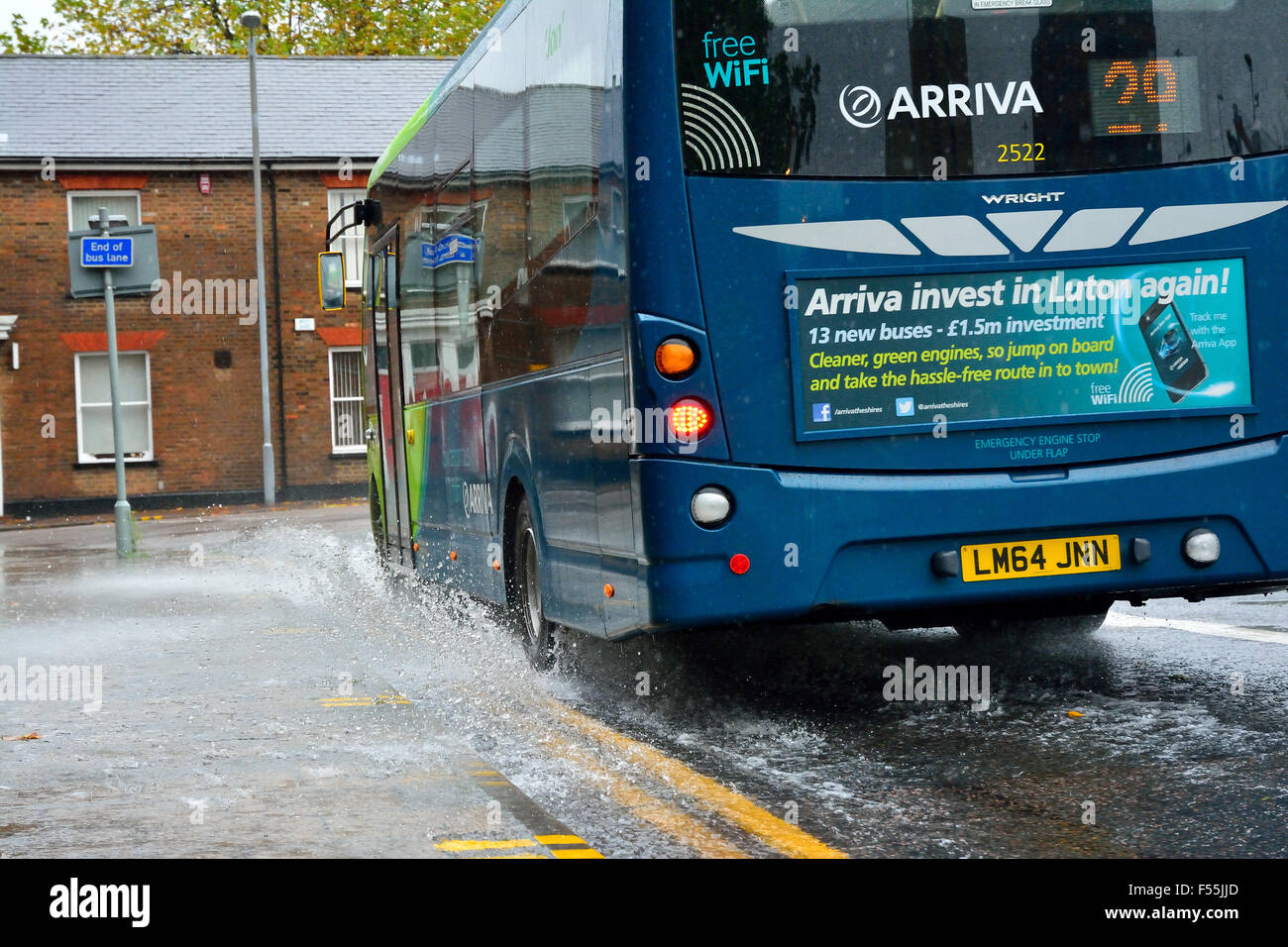 Bus driving through rain puddles in Luton, Bedfordshire, England Stock ...