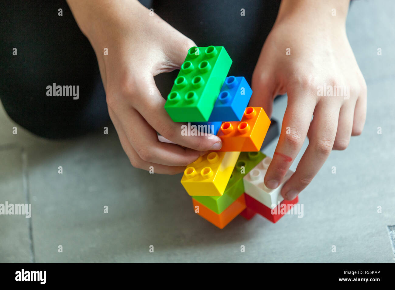 Plastic cubes in the hands of a child's game that develops creativity ...