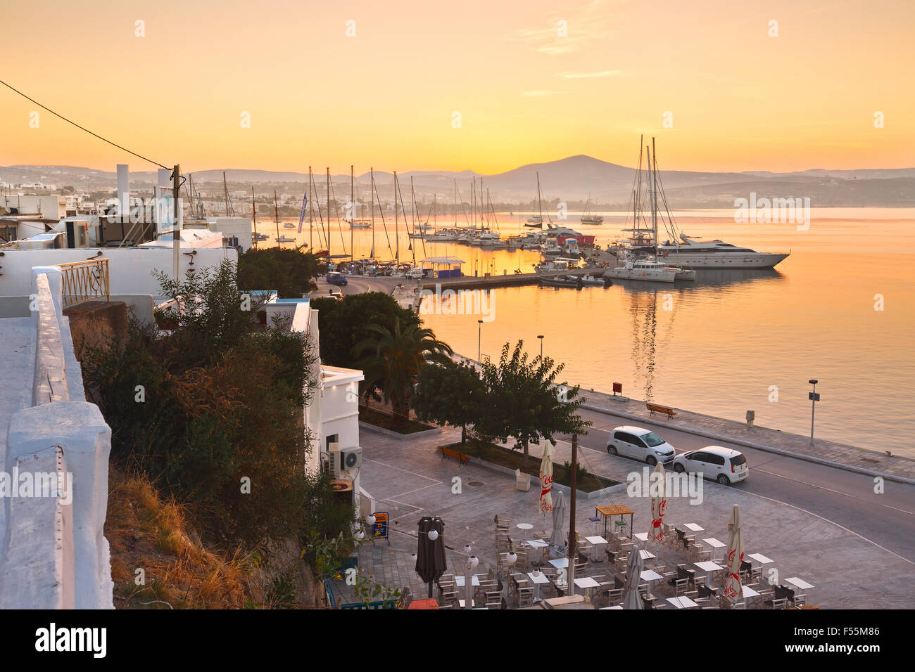 Adamantas harbour and seafront on an early morning Stock Photo - Alamy
