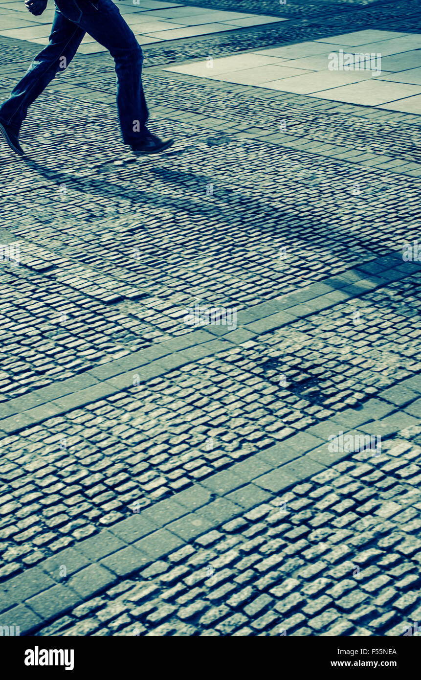 Mysterious man running on a cobbled street Stock Photo - Alamy